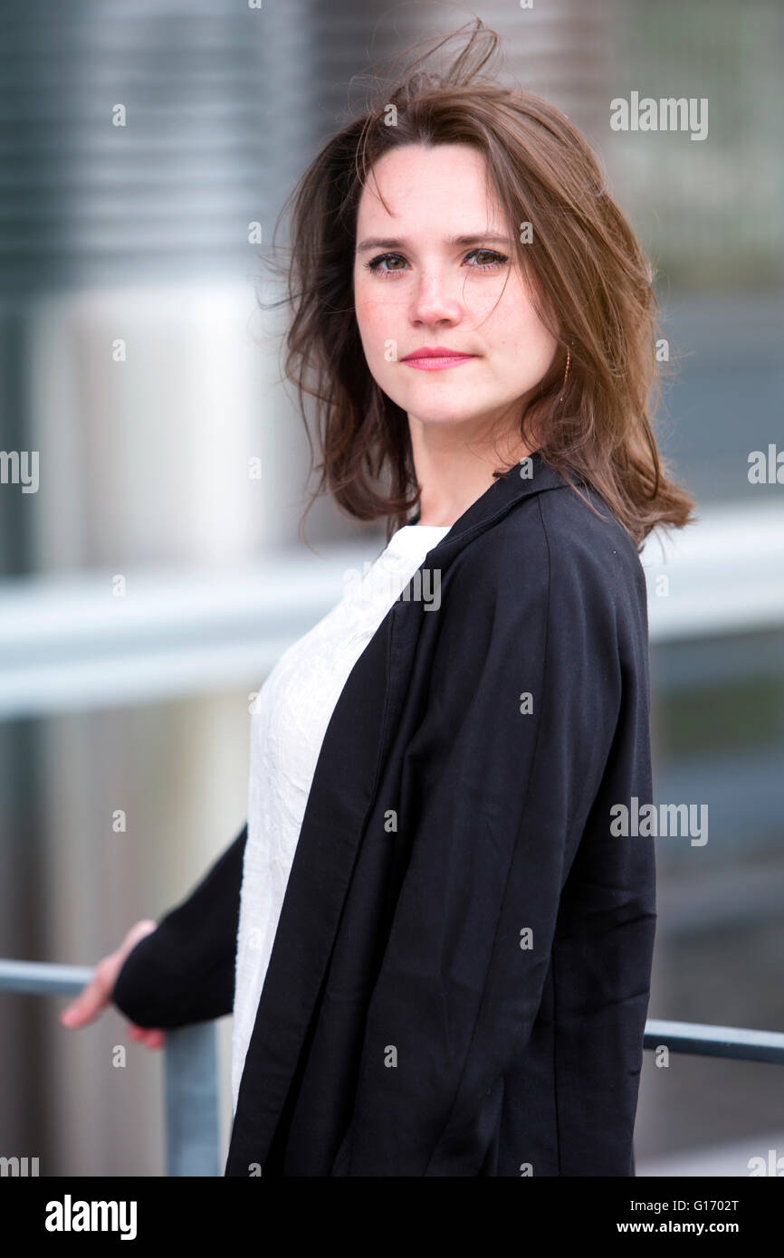 portrait of a young woman standing outside Stock Photo - Alamy