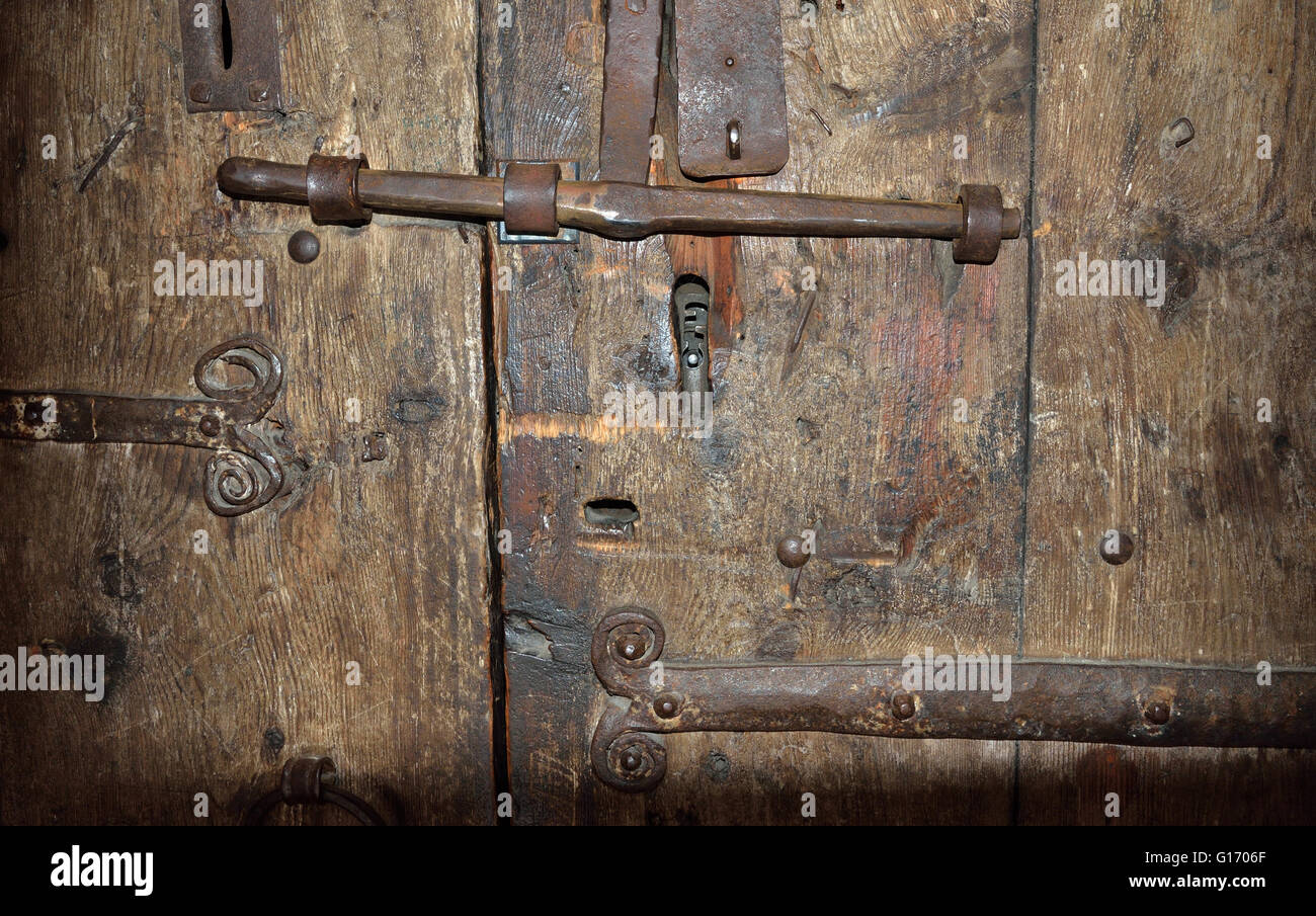 The big metal lock with a latch on the wooden surface of the ancient ...