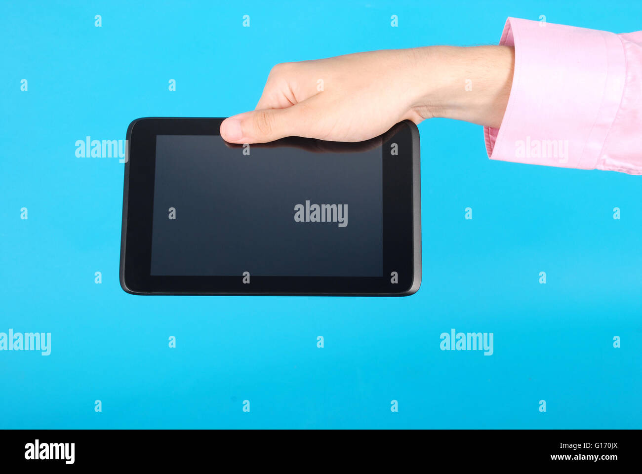 Male hand holding a touchscreen isolated on blue background Stock Photo ...