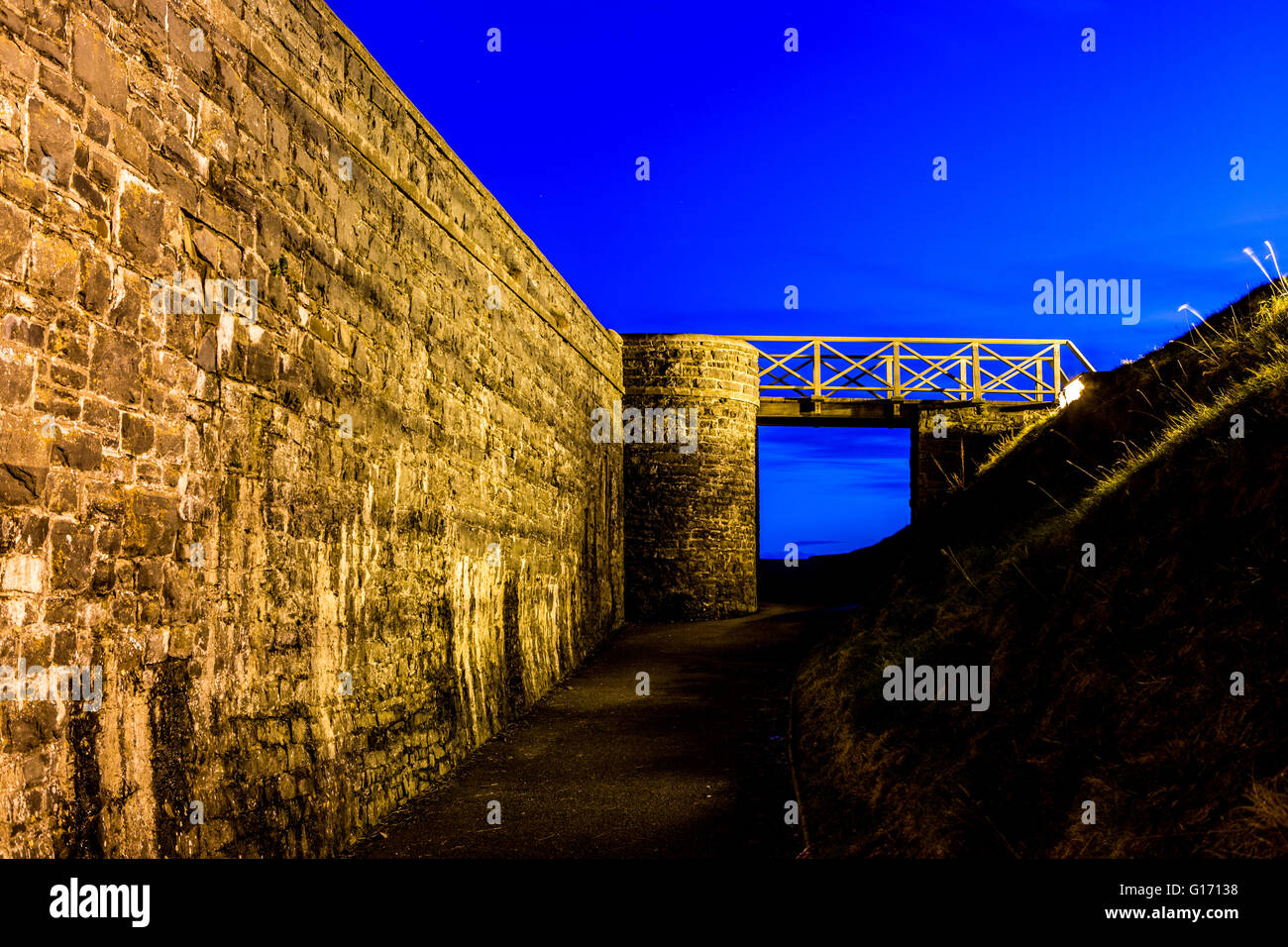 Walkway along a castle wall night Stock Photo - Alamy