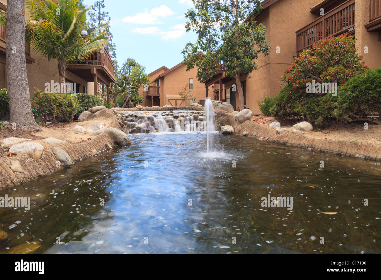 Orange, CA, USA —May 7, 2016: Plant life, koi fish and a waterfall in a ...