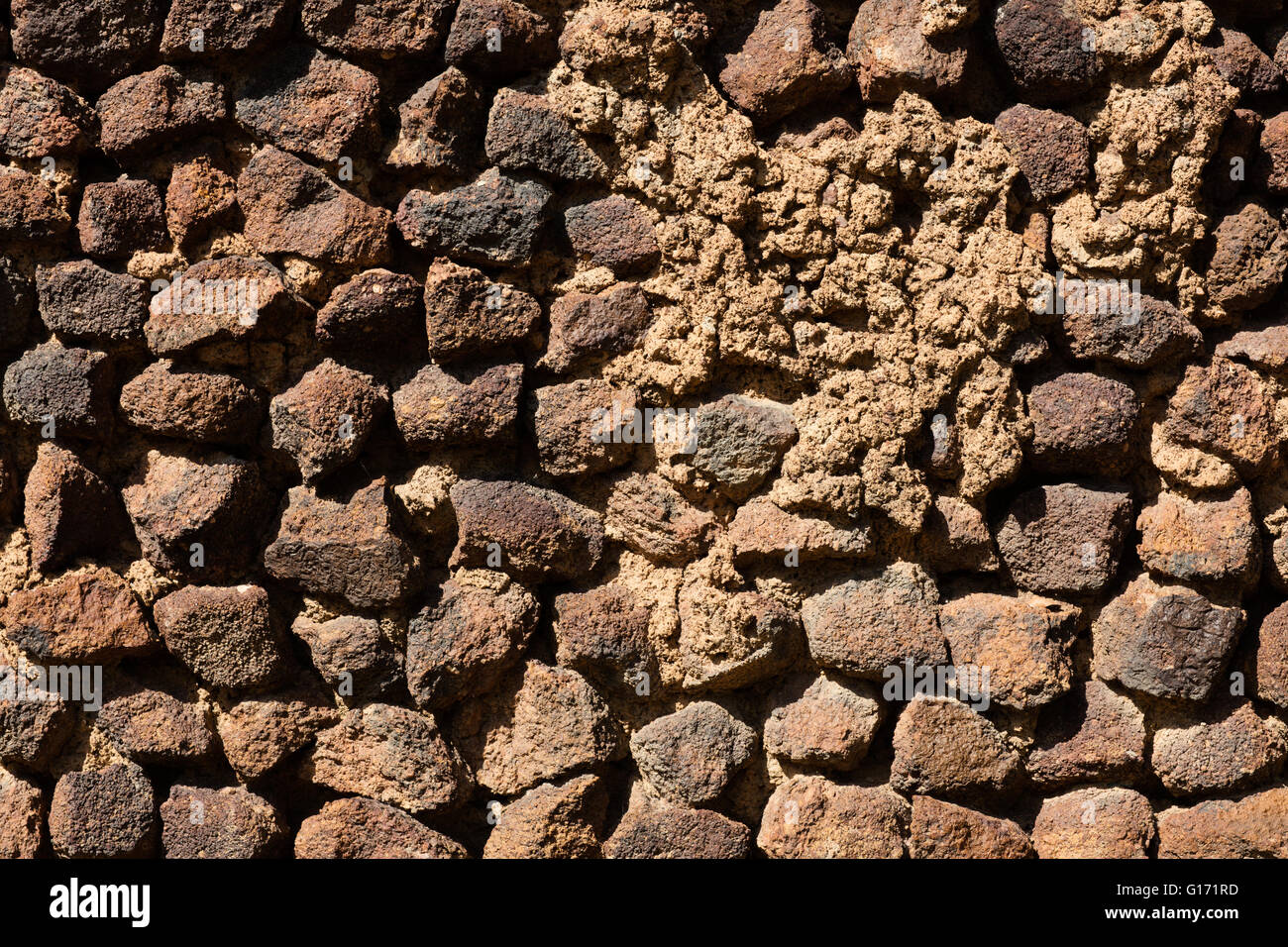 Backround of wall of brick in tuff and stone Stock Photo - Alamy