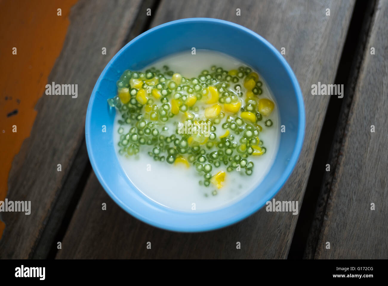 Tapioca pudding or Sakoo (Thai dessert) with coconut milk on wood table ...