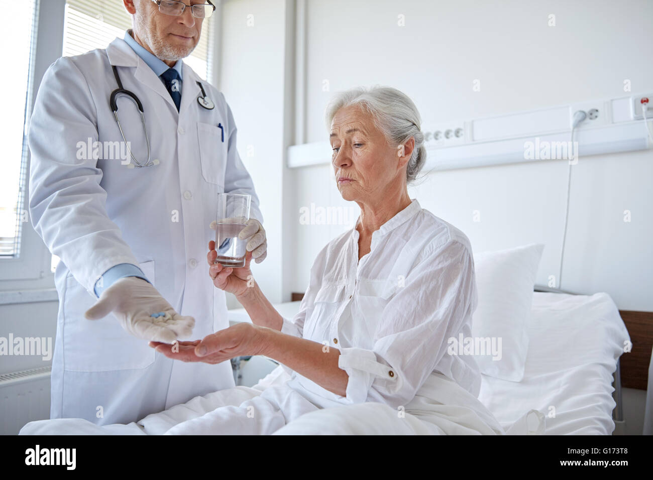 doctor giving medicine to senior woman at hospital Stock Photo - Alamy