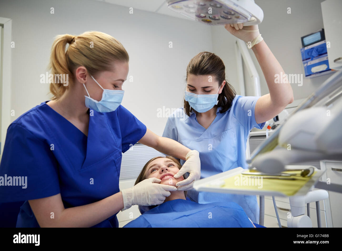 happy female dentist with patient girl at clinic Stock Photo - Alamy