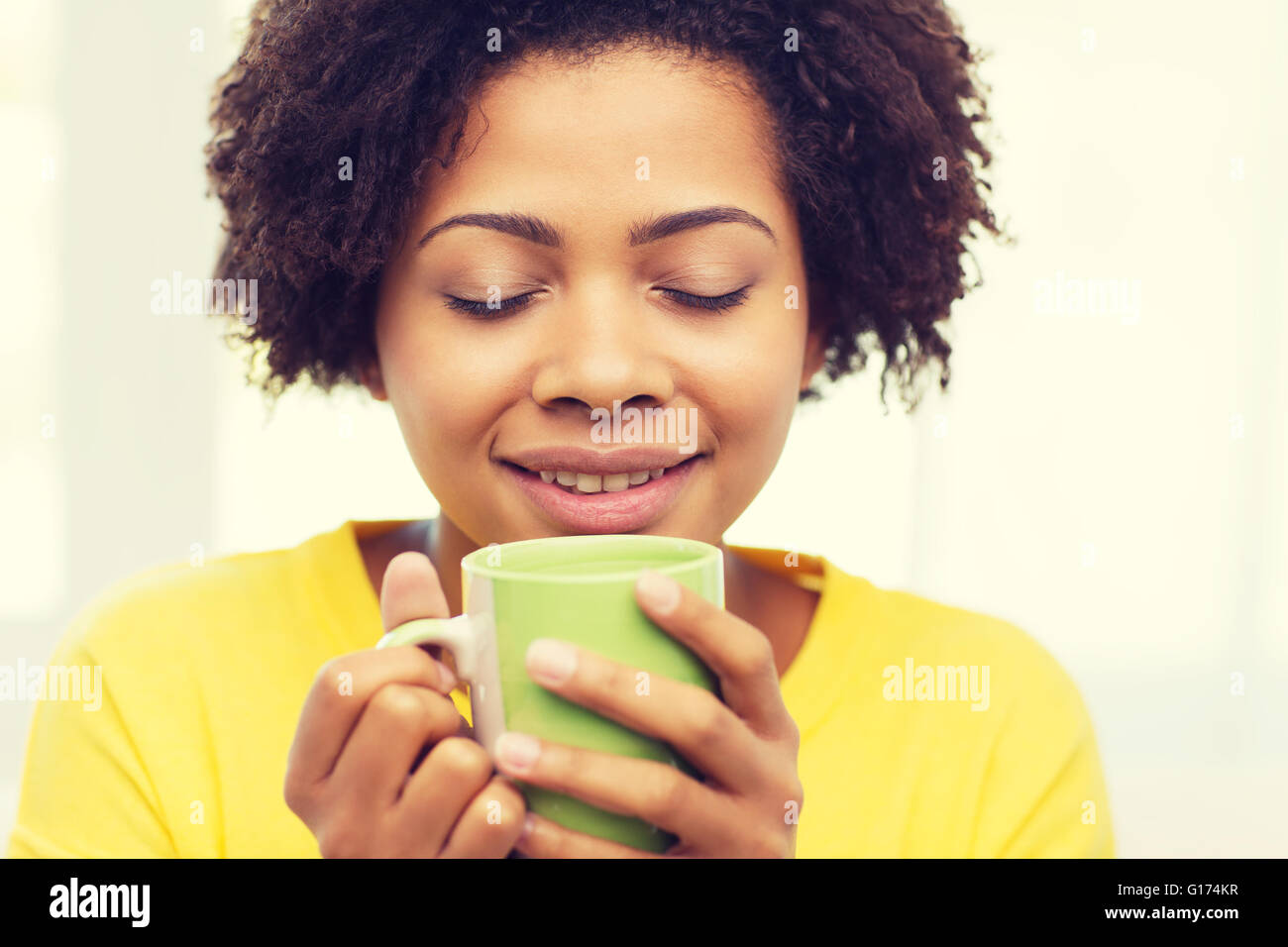 happy african american woman drinking from tea cup Stock Photo - Alamy