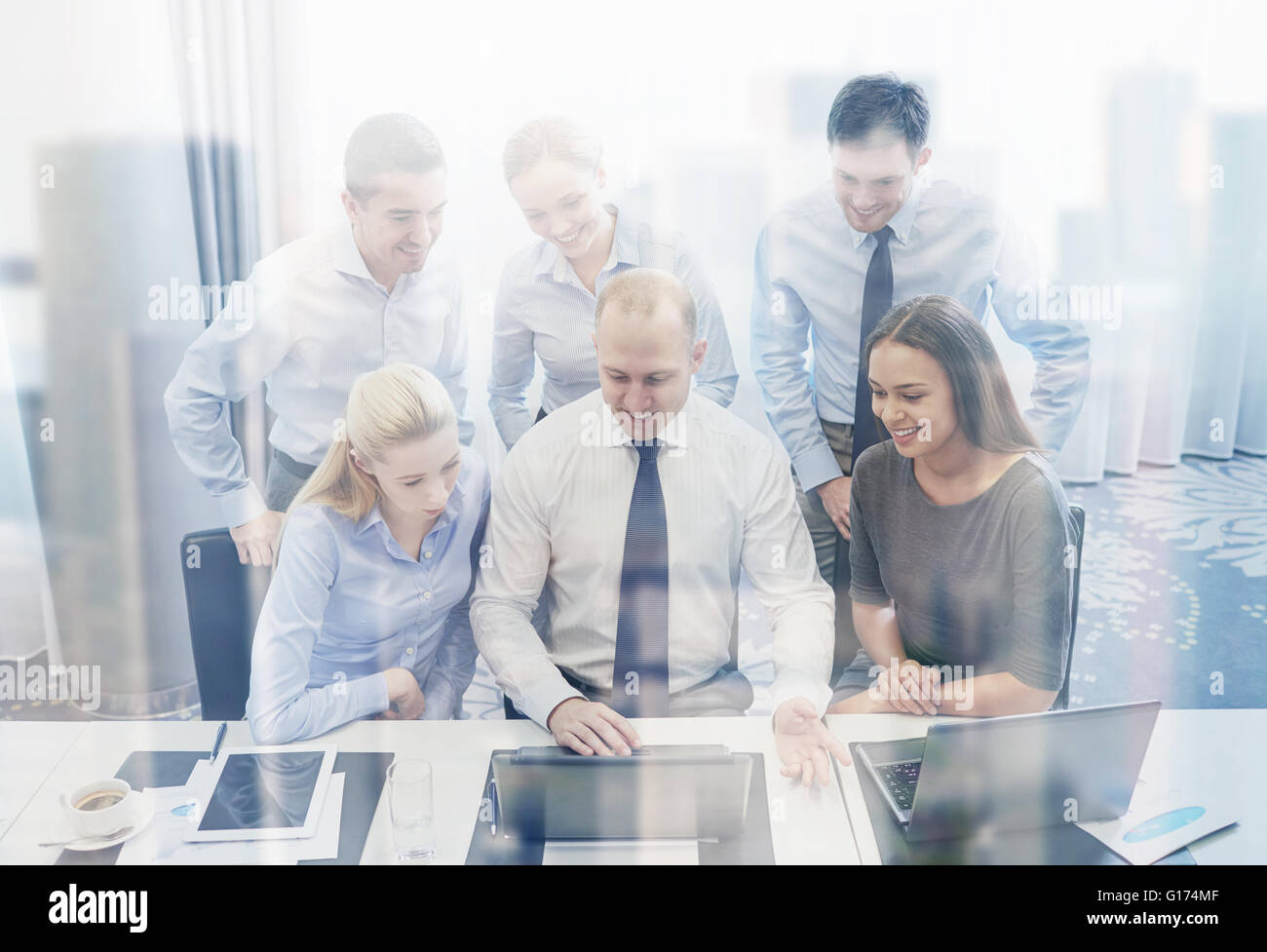 smiling business people with laptop in office Stock Photo - Alamy