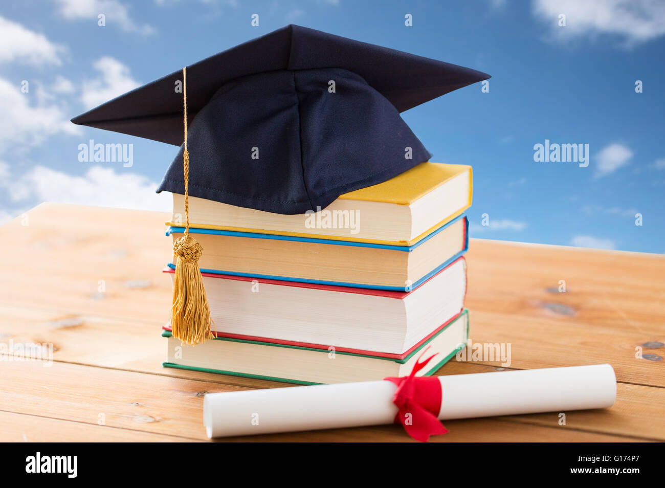 close up of books with diploma and mortarboard Stock Photo - Alamy