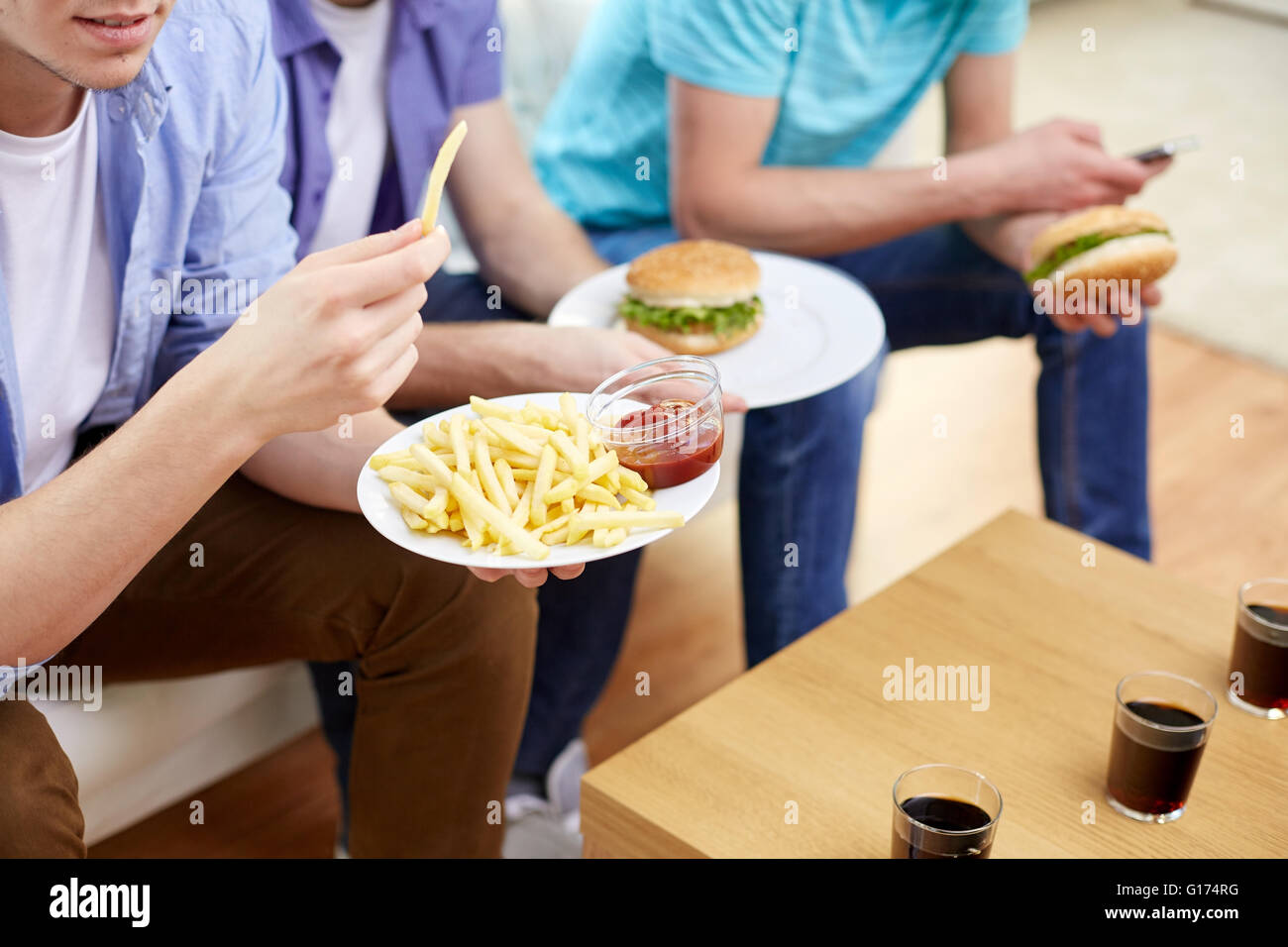 Man eating hamburger fries hi-res stock photography and images - Alamy