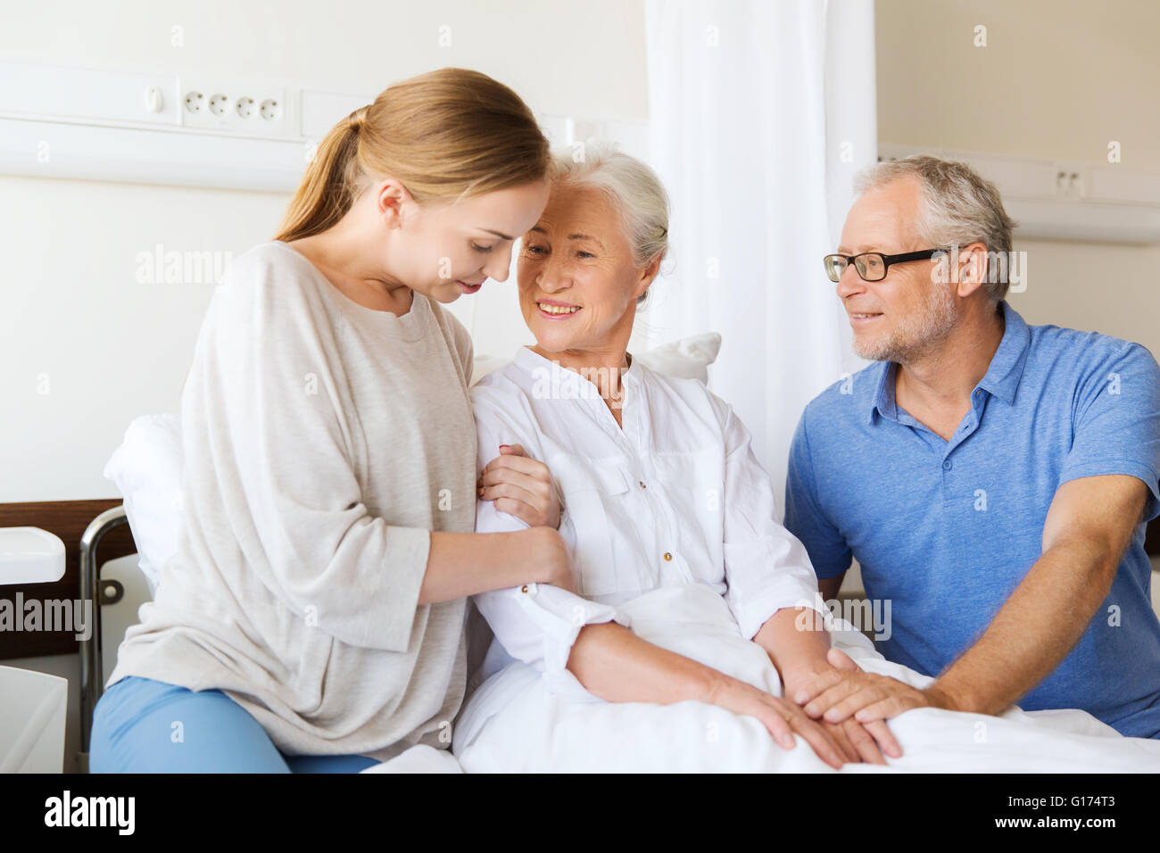 happy family visiting senior woman at hospital Stock Photo - Alamy