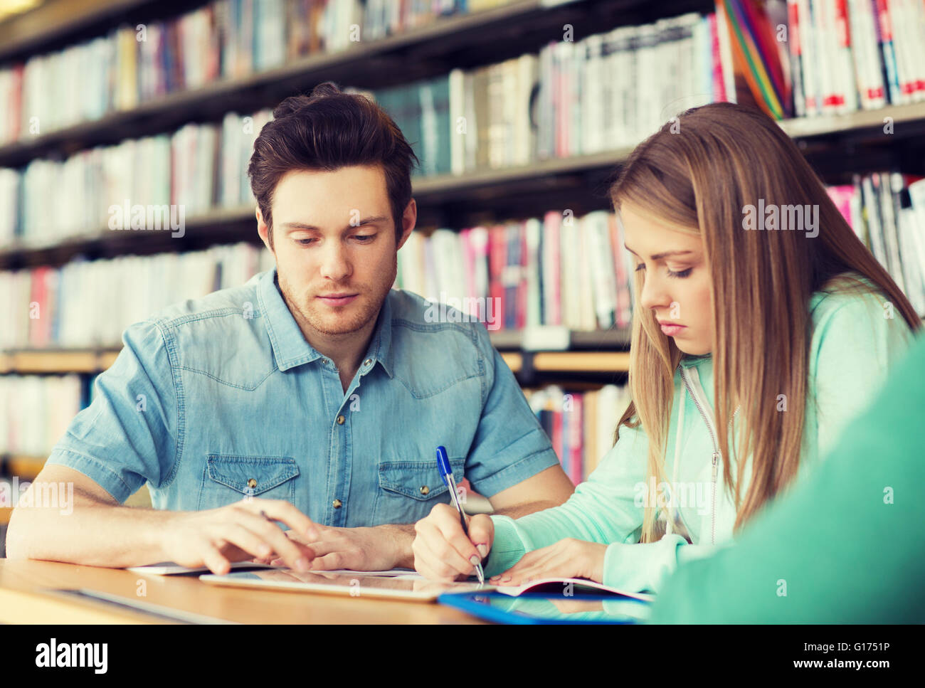 students writing to notebooks in library Stock Photo - Alamy