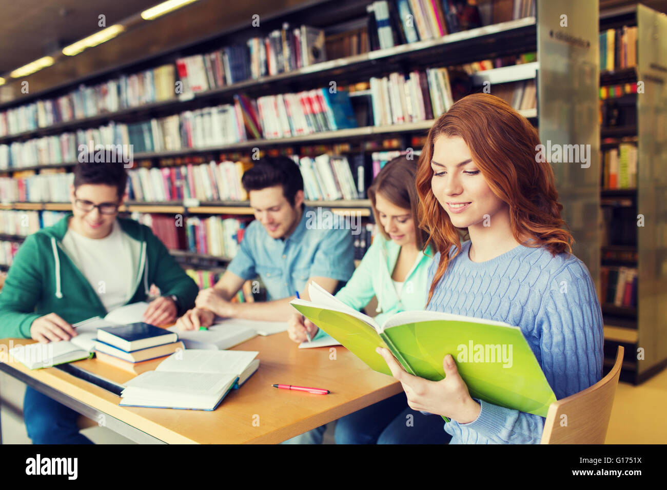 happy students reading books in library Stock Photo - Alamy