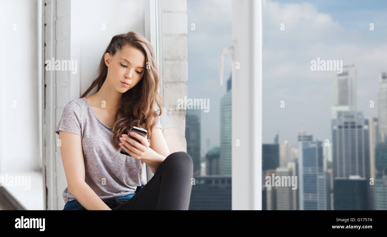 sad pretty teenage girl with smartphone texting Stock Photo - Alamy