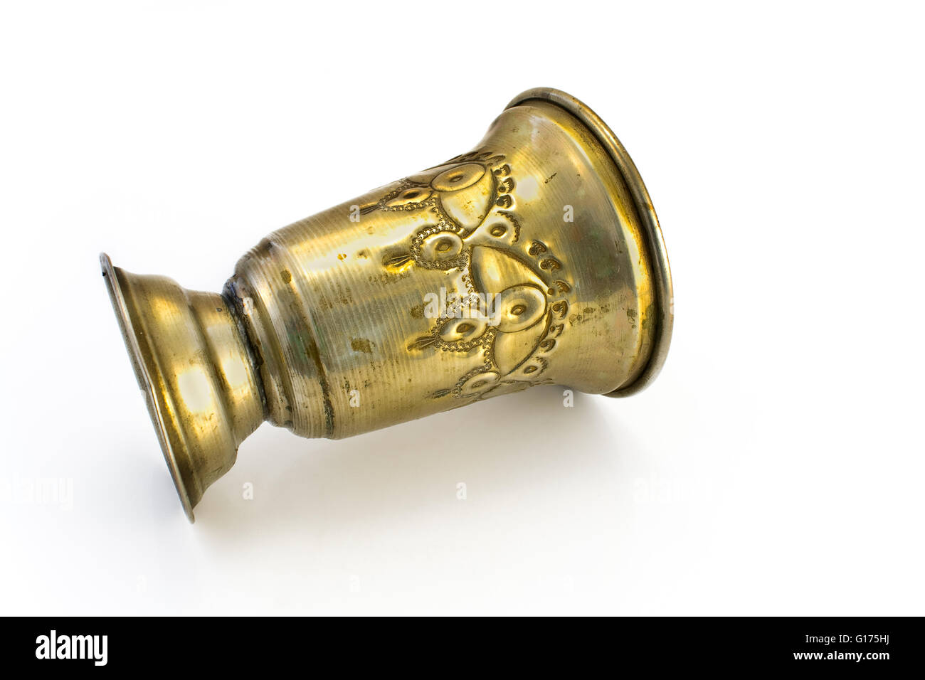 Turned over golden goblet isolated on white Stock Photo - Alamy