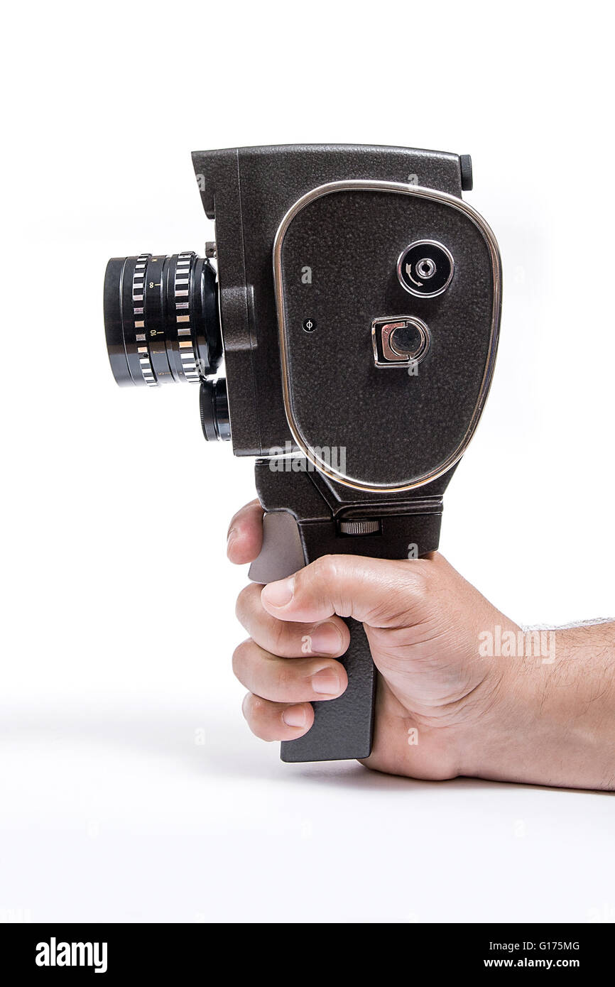 Old movie camera with lens in hand isolated on a white background Stock ...