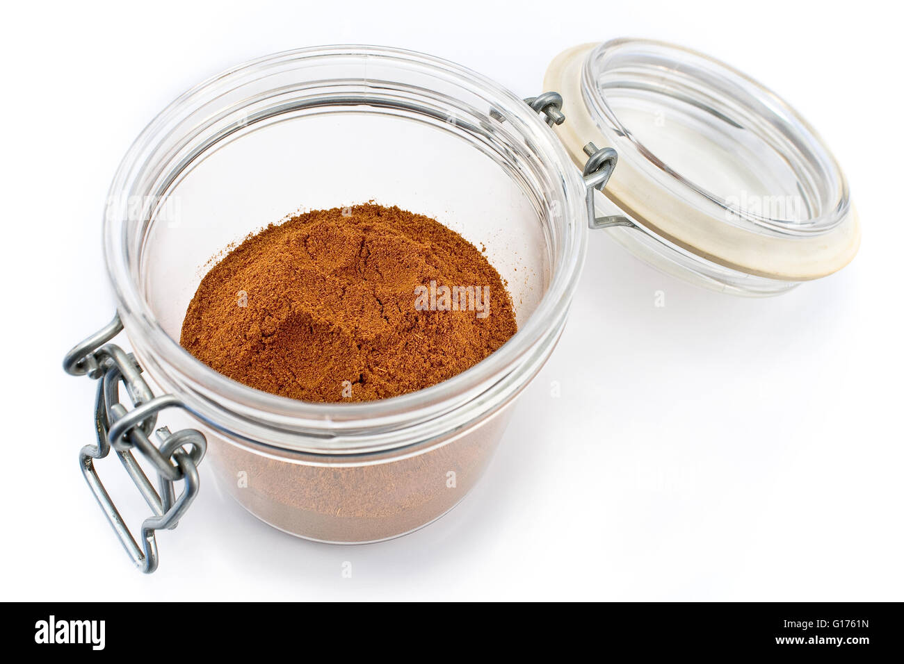 Red pepper powder in open jar isolated on white Stock Photo - Alamy