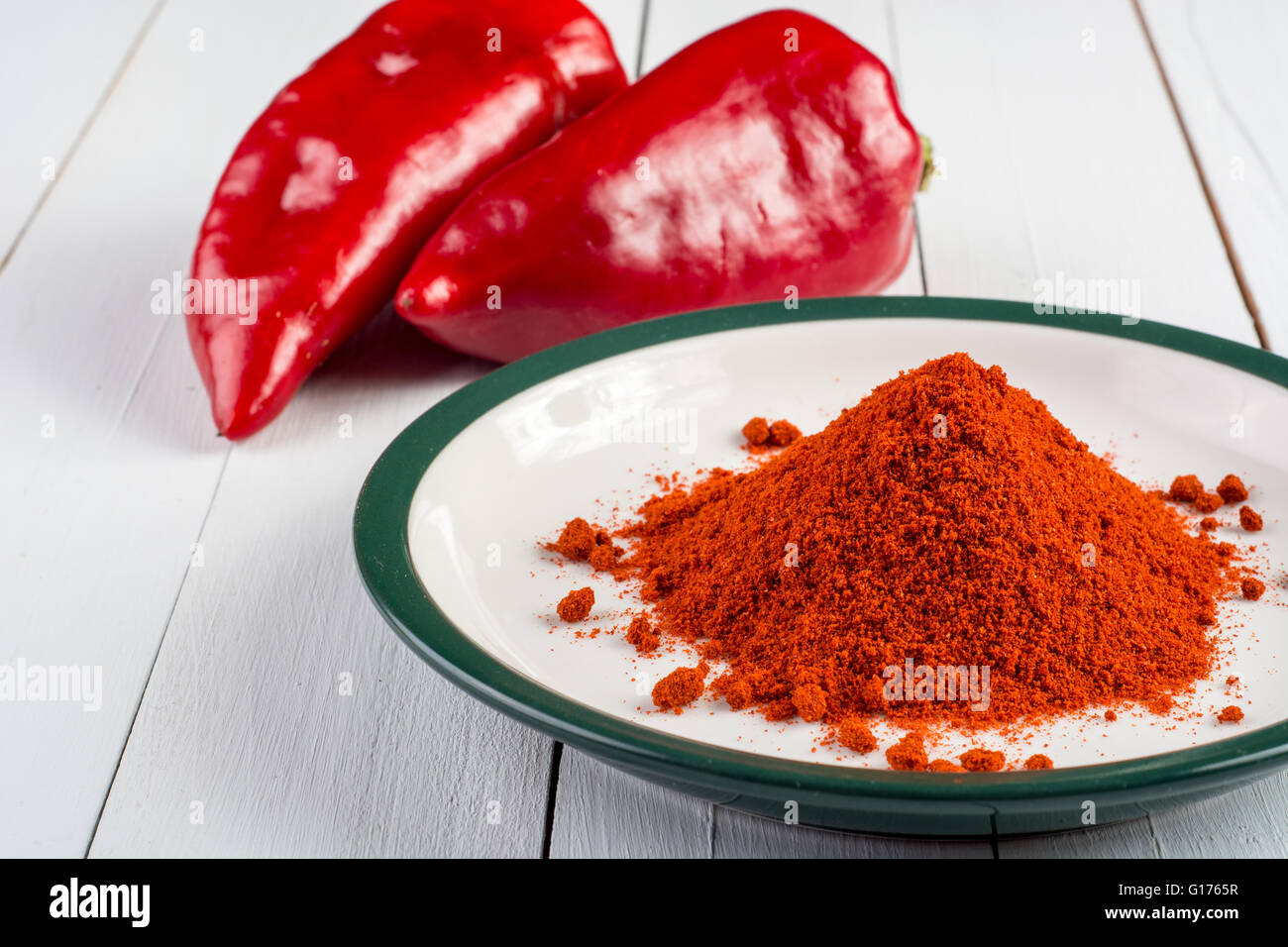 Powdered and fresh red paprika on wooden table Stock Photo - Alamy