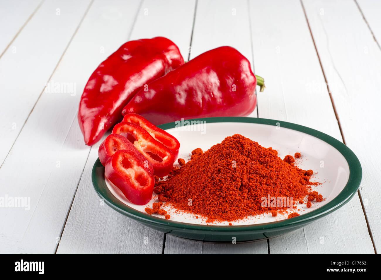 Powdered and fresh red paprika on wooden table Stock Photo - Alamy