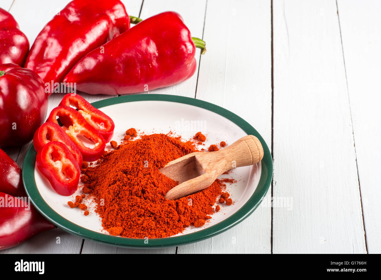 Powdered and fresh red paprika on wooden table Stock Photo - Alamy