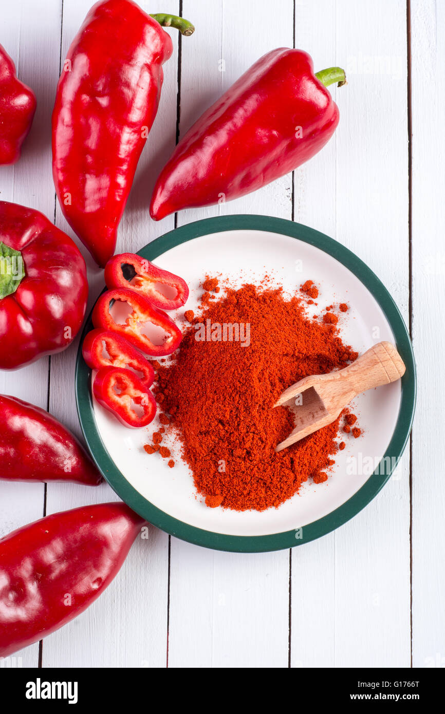 Powdered and fresh red paprika on wooden table Stock Photo - Alamy