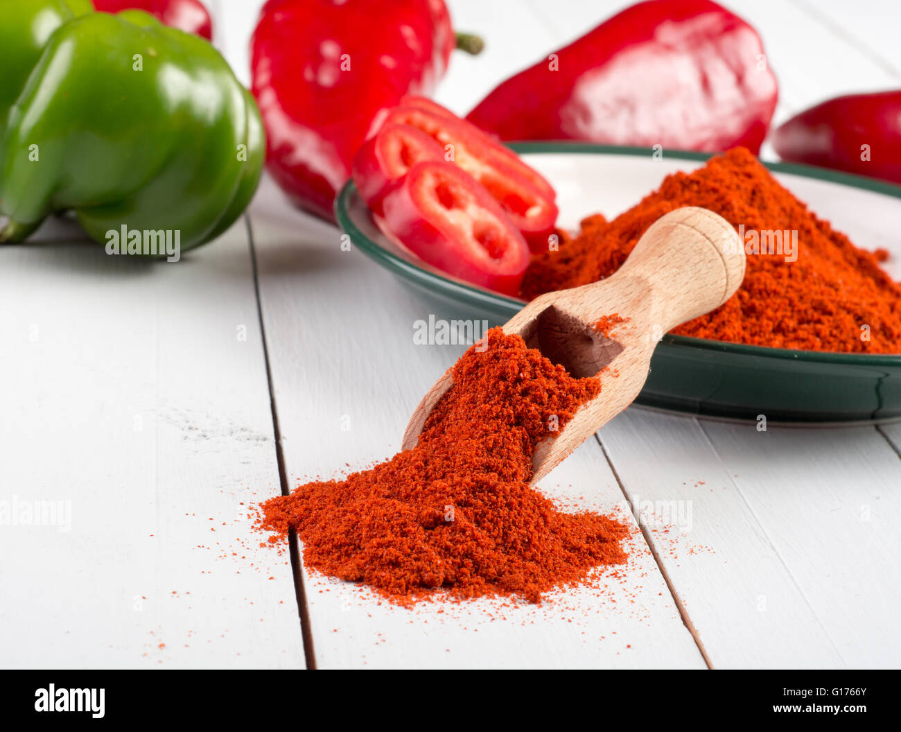 Powdered and fresh red paprika on wooden table Stock Photo - Alamy