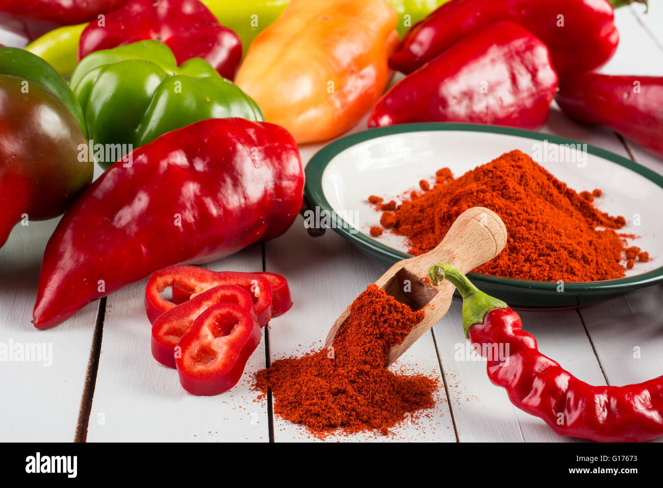 Powdered and fresh red paprika on wooden table Stock Photo - Alamy
