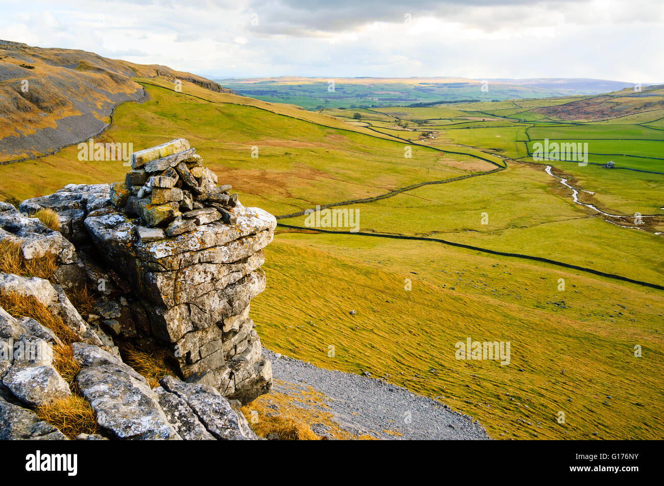 Cairn on limestone crag at Moughton Scars above Crummackdale in the ...