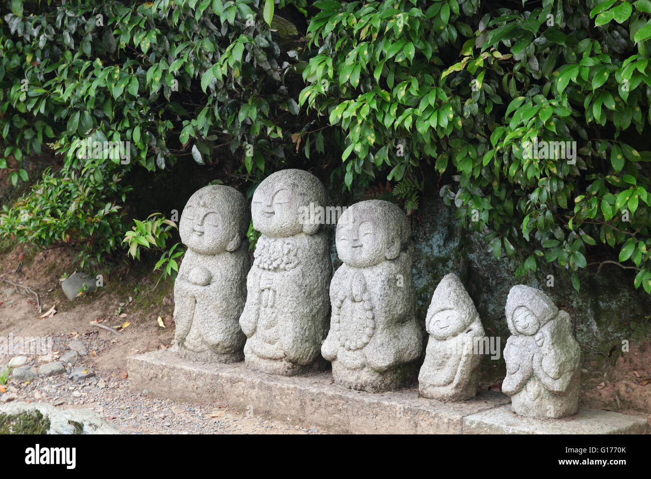 Smiling Buddha Stone statues Stock Photo - Alamy