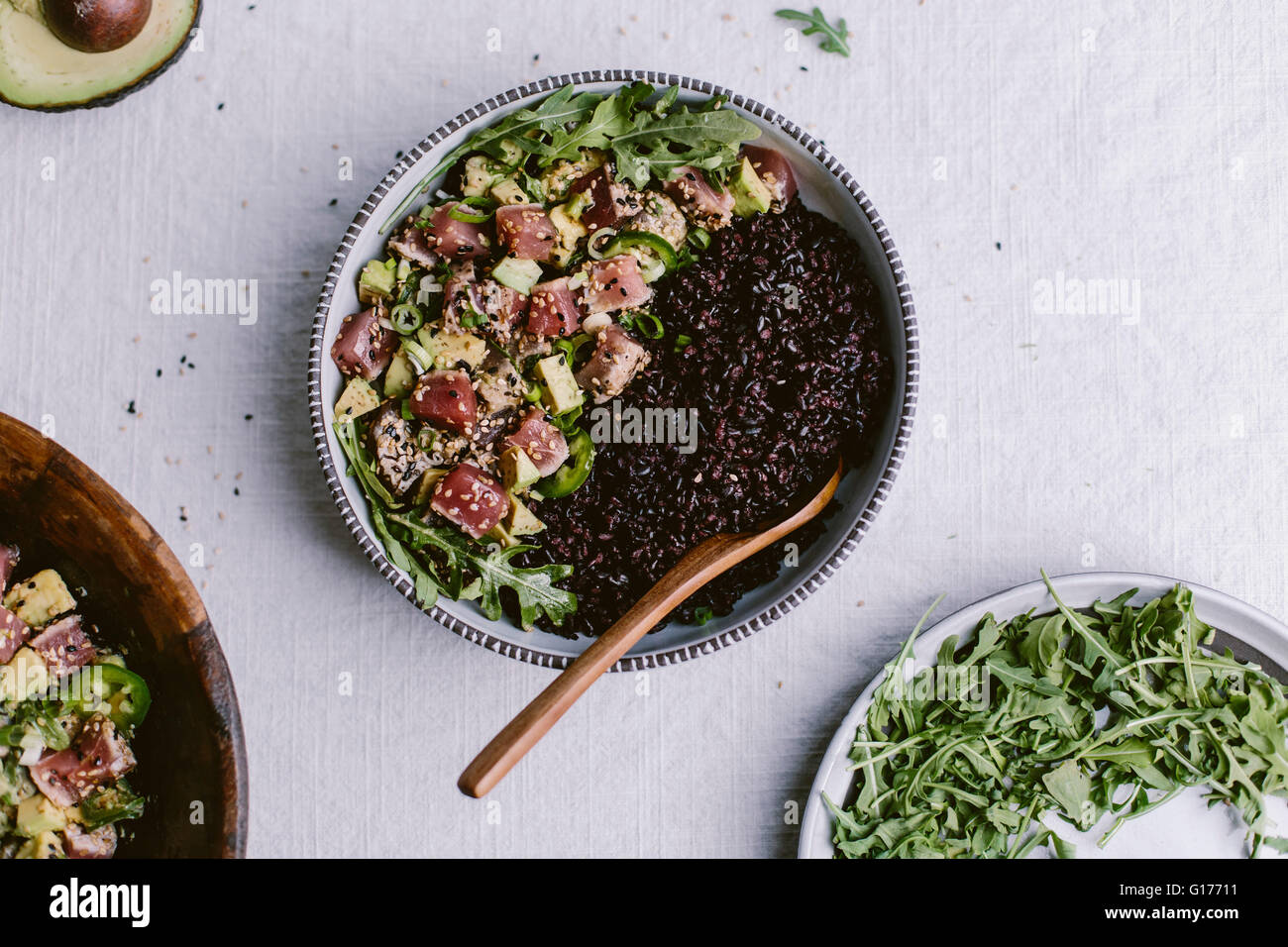 A bowl of Sesame Crusted Seared Tuna Salad and forbidden rice bowl is ...