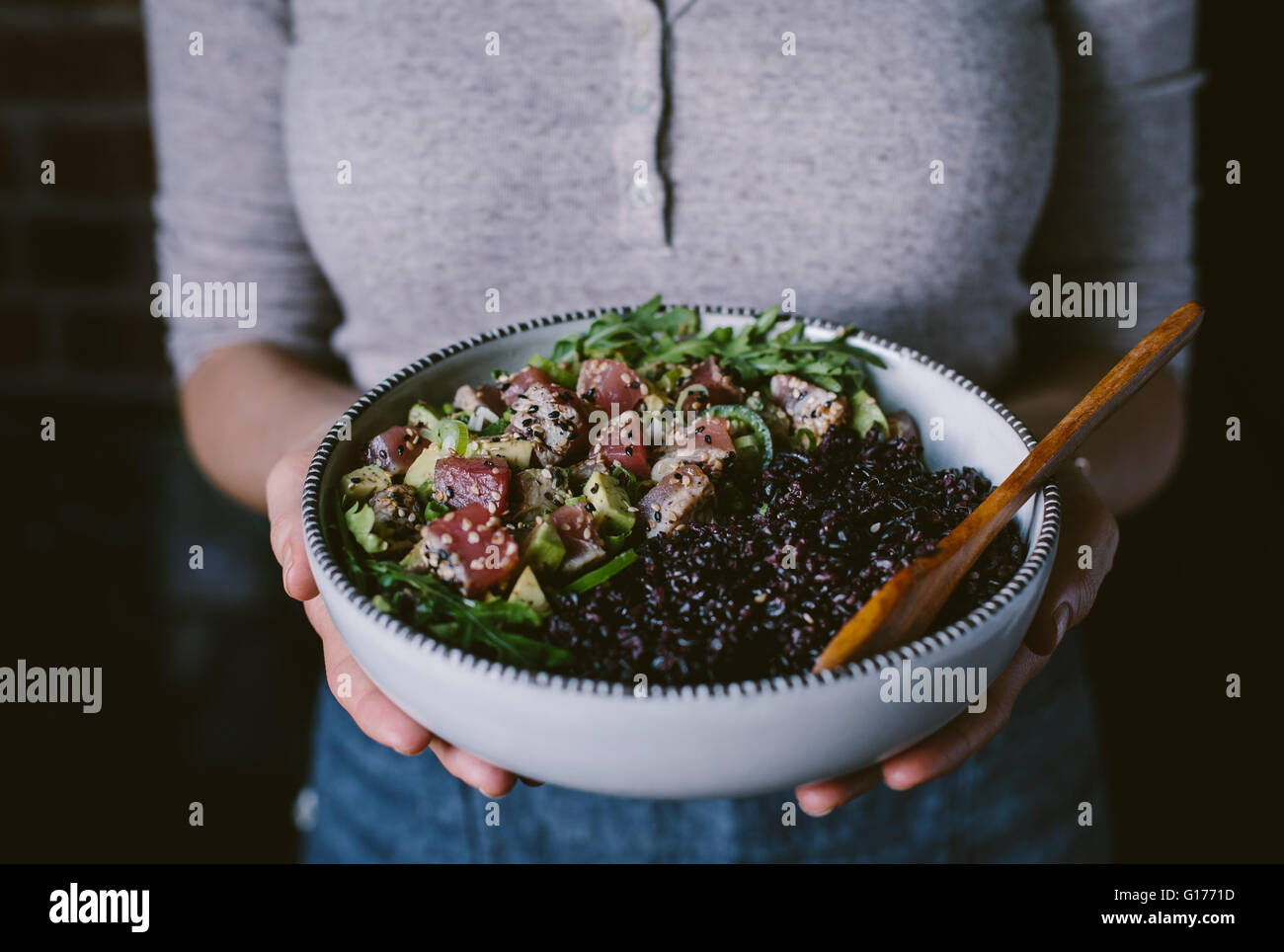 A woman is holding a bowl filled with Sesame Crusted Seared Tuna Salad ...