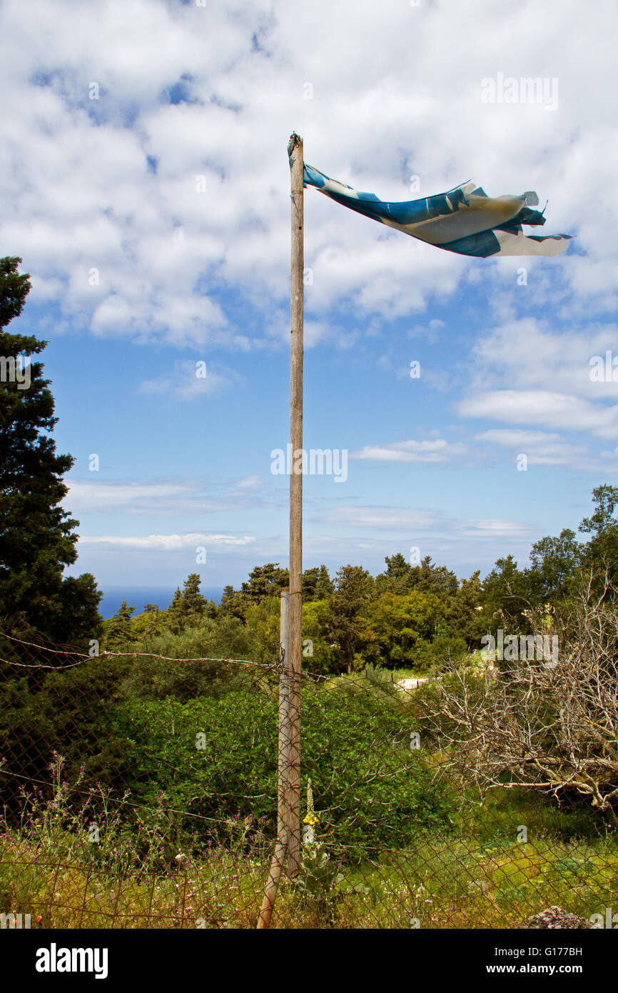 A shredded, torn flag of Greece in a rural landscape Stock Photo - Alamy