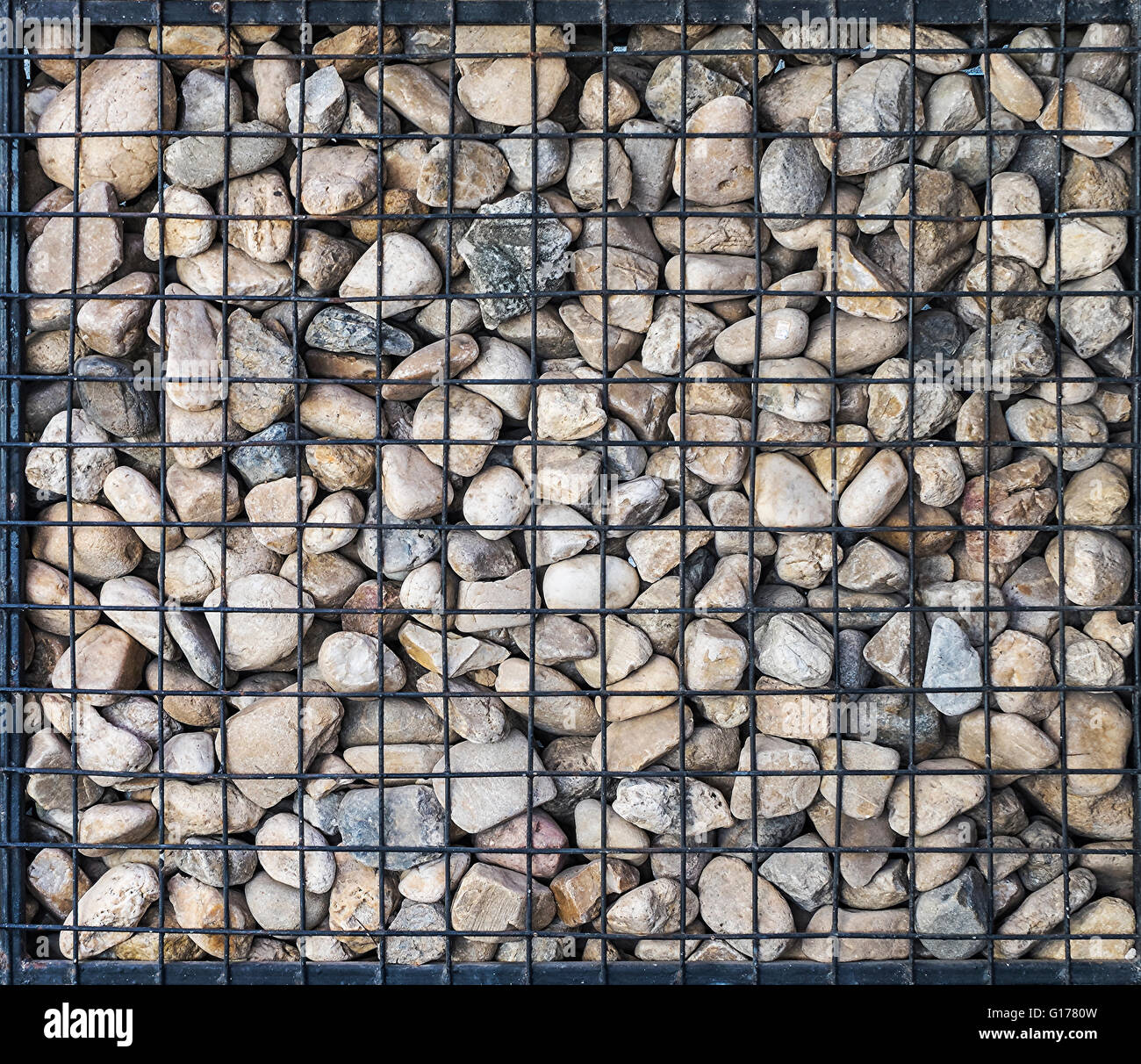 pebble stones in iron mesh Stock Photo - Alamy