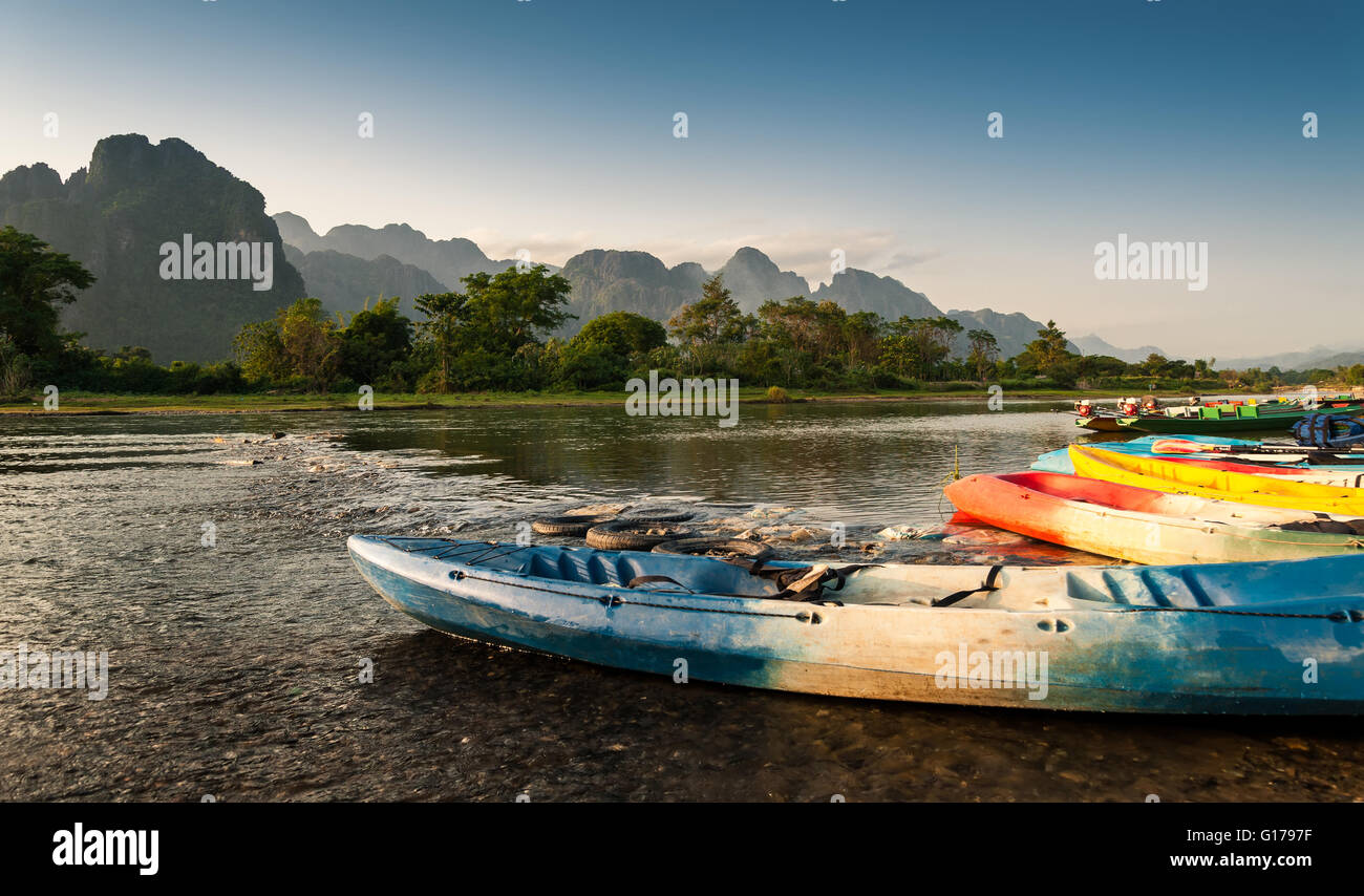 kayak and longtail boats in Nam Song river at Vang Vieng, Laos Stock ...