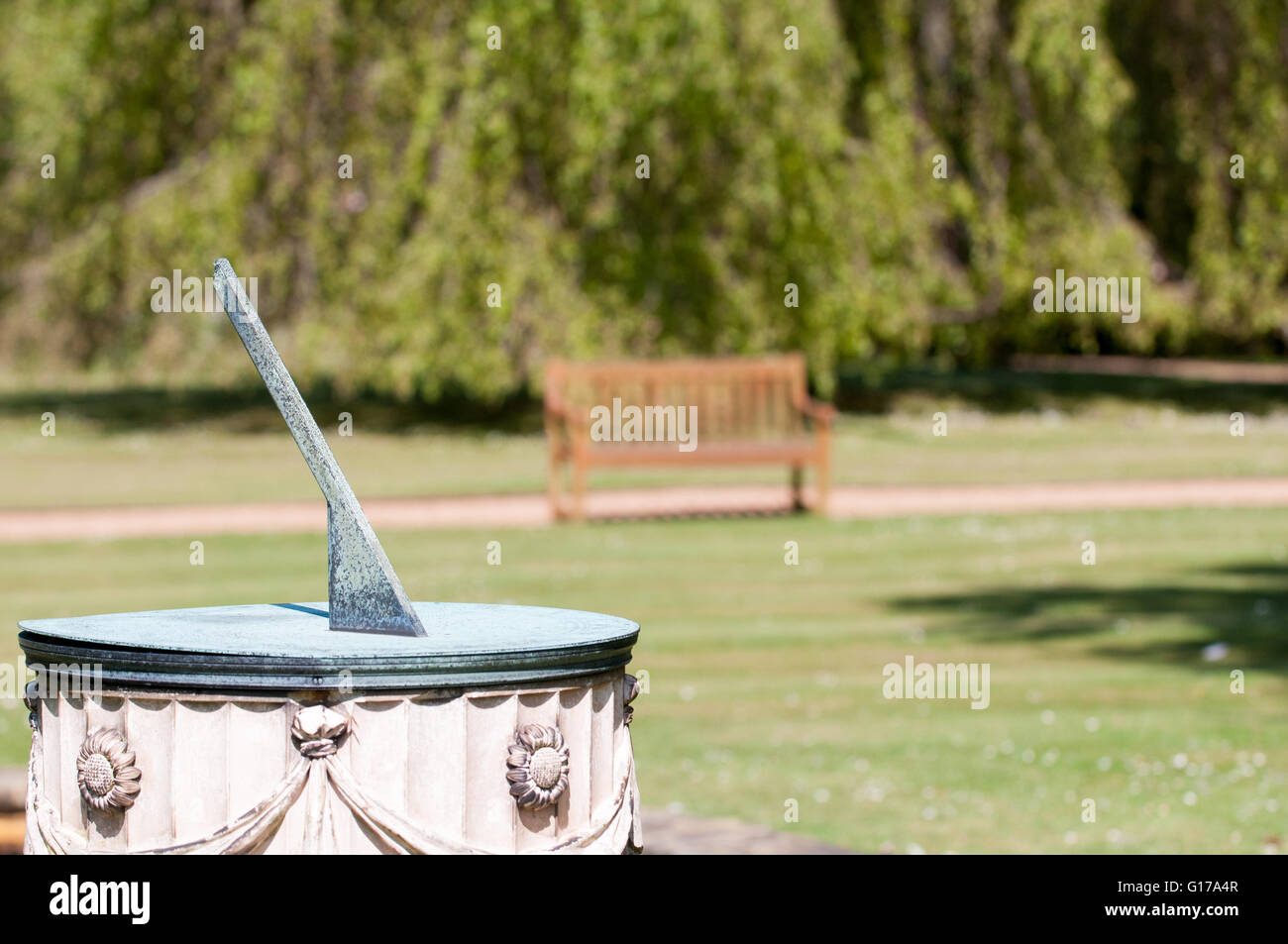 Sundial in the grounds of a garden in bright sunlight Stock Photo - Alamy