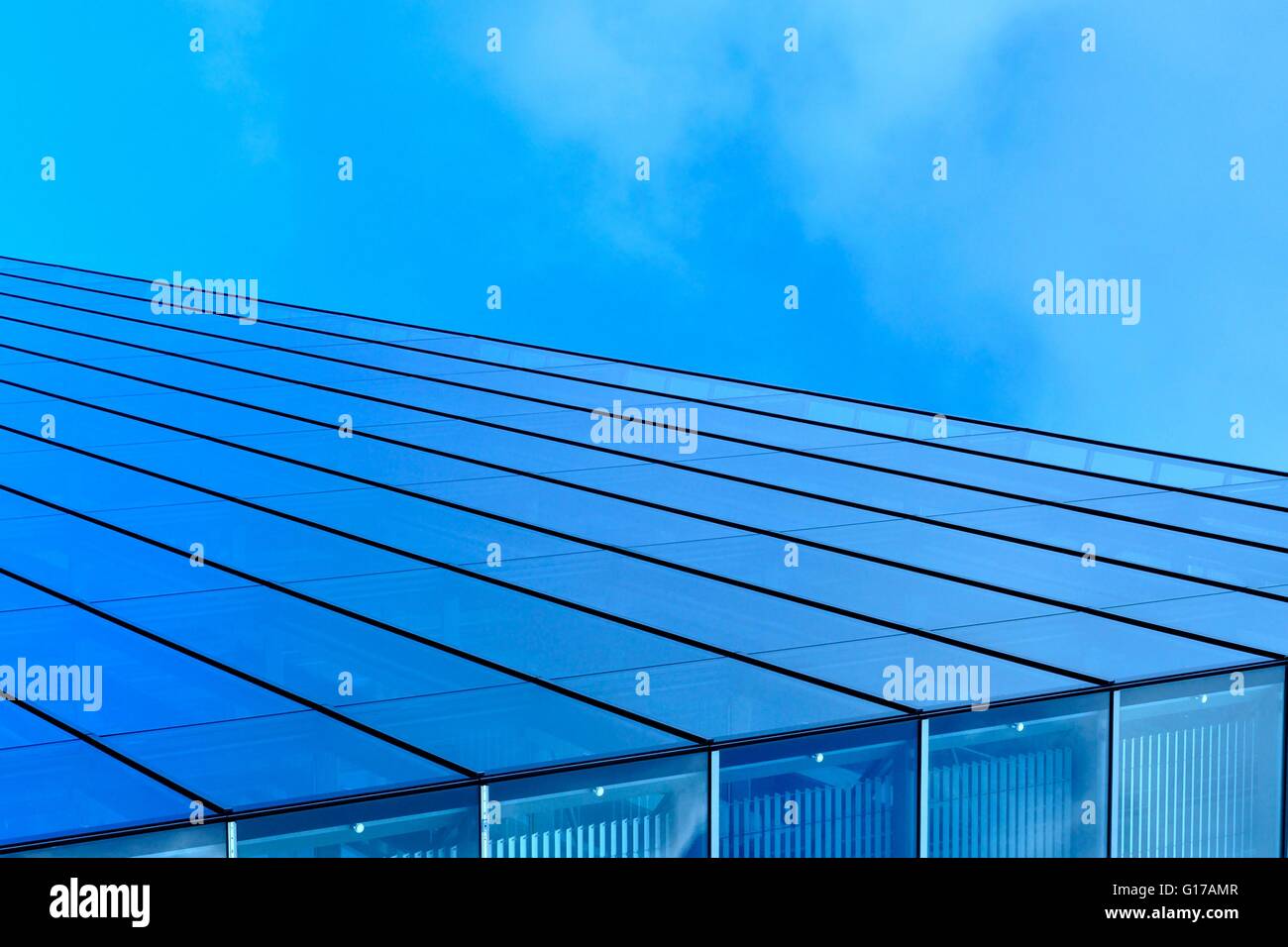 Abstract view of modern blue glass business center on a clear sky ...