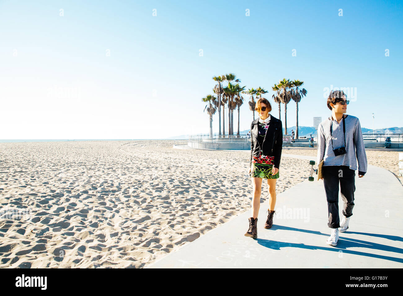 Woman walking along palm hi-res stock photography and images - Alamy