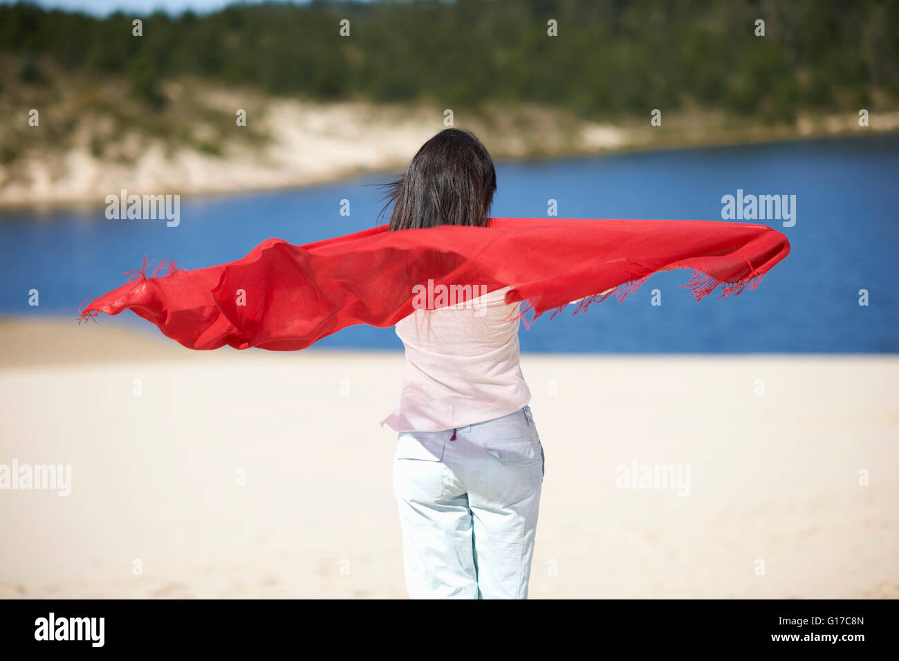 Woman in red shawl enjoying beach Stock Photo - Alamy