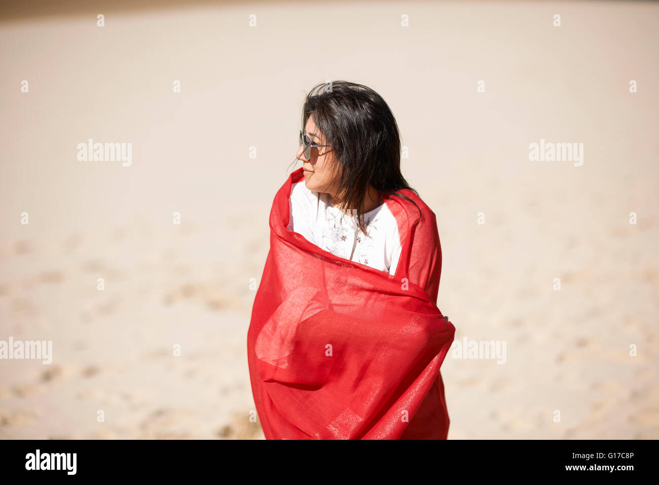 Woman in red shawl enjoying beach Stock Photo - Alamy