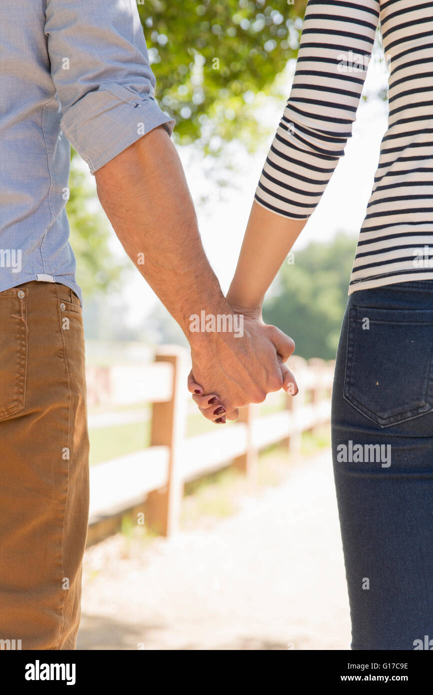 Cropped rear view of couple holding hands Stock Photo - Alamy
