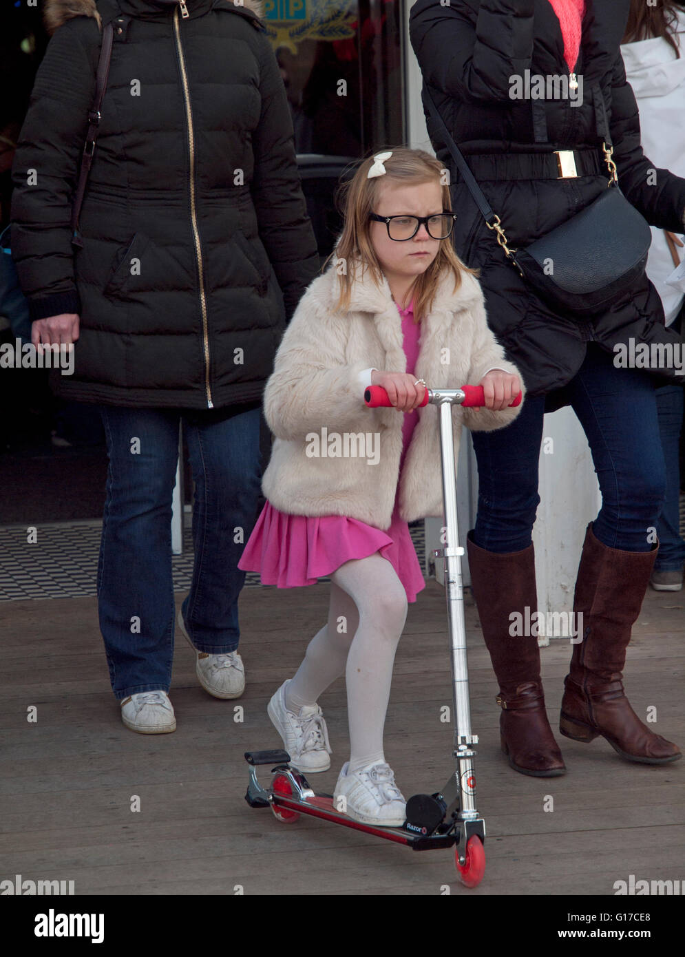 A bespectacled girl on her scooter Stock Photo - Alamy