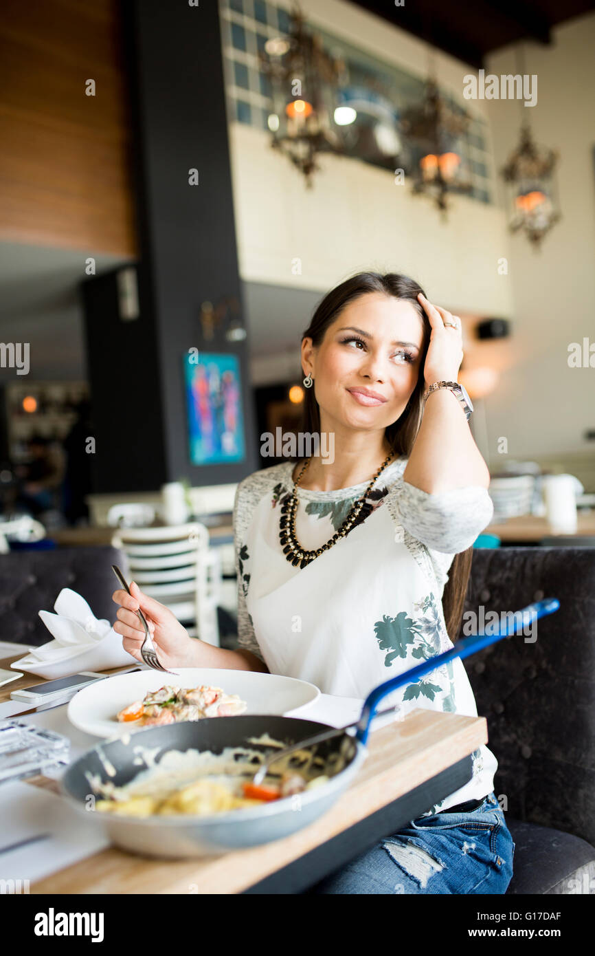 Woman at the table in the restaurant Stock Photo - Alamy