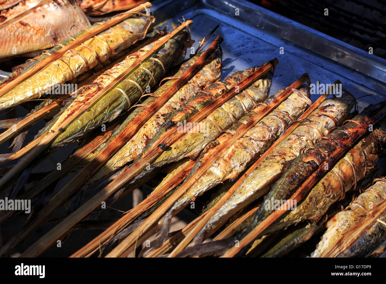 Traditional Cambodian style of cooking fish grill Stock Photo - Alamy