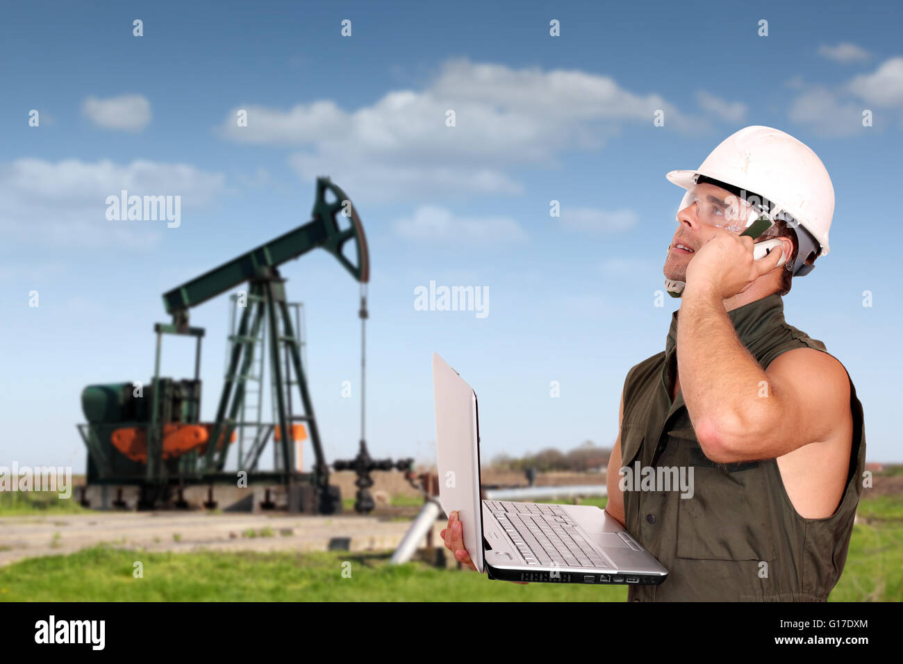 oil worker with laptop and phone Stock Photo - Alamy