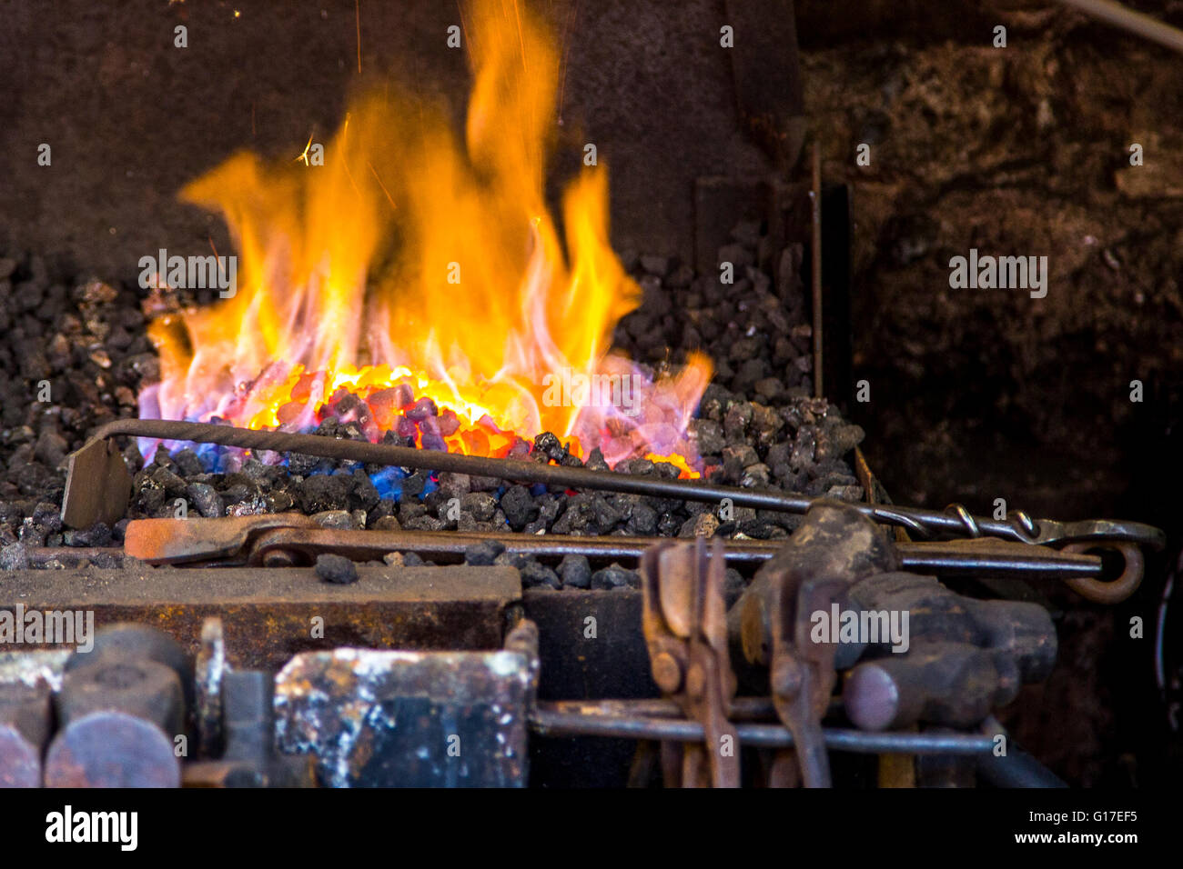 A working Forge and blAcksmith at work in Cockington Village Stock ...
