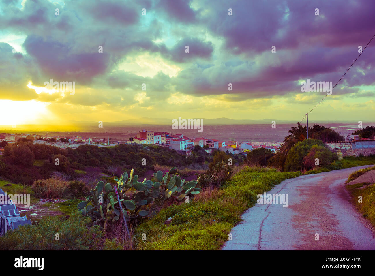 Road with vanishing point in italian countryside with view on a city ...