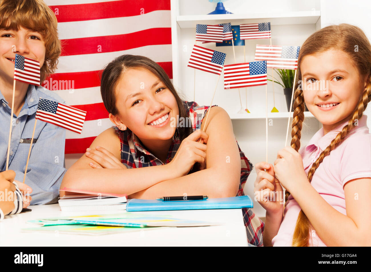 Smiling students with American flags at the class Stock Photo - Alamy