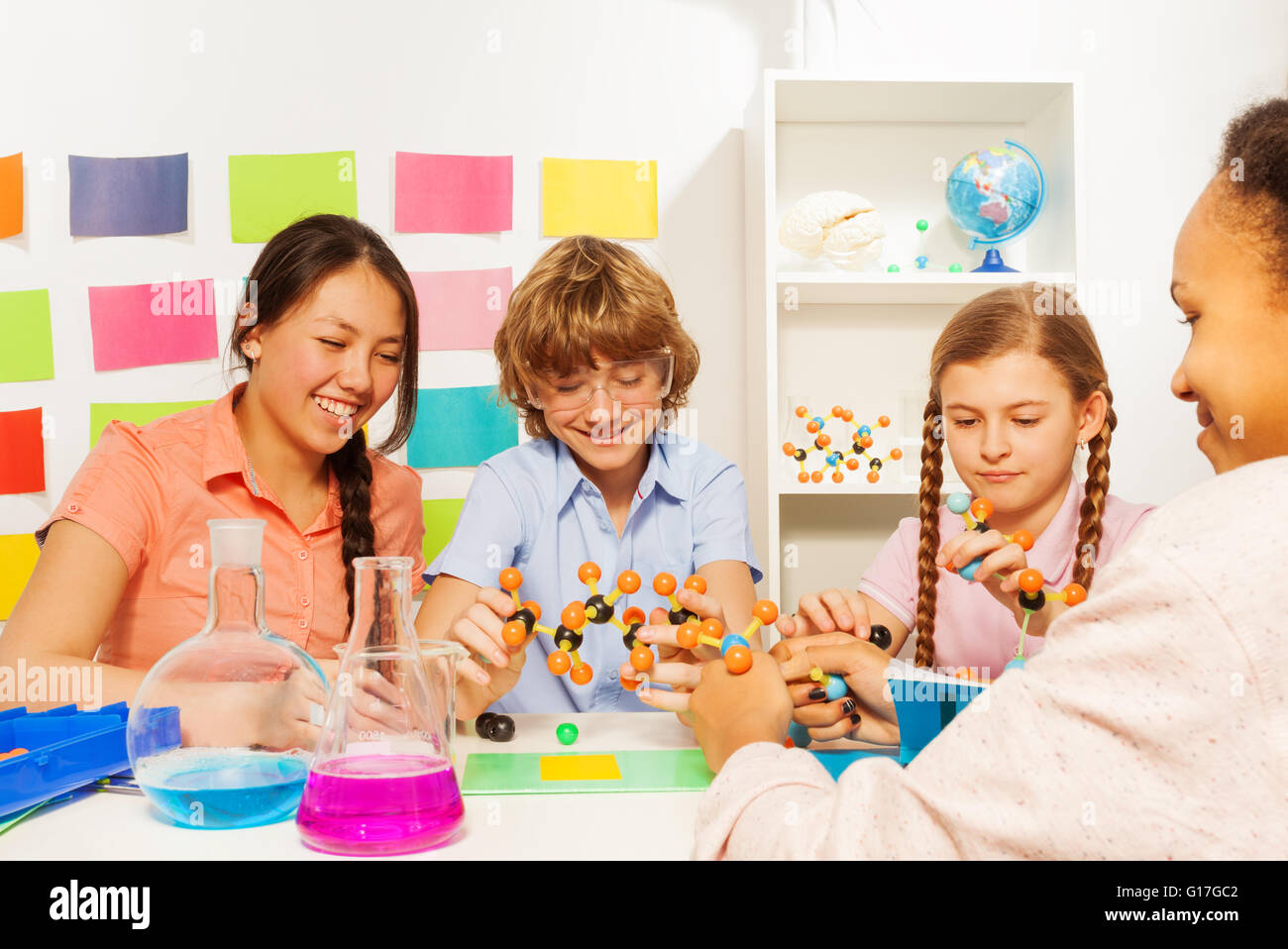 Four students studying chemistry at the classroom Stock Photo - Alamy