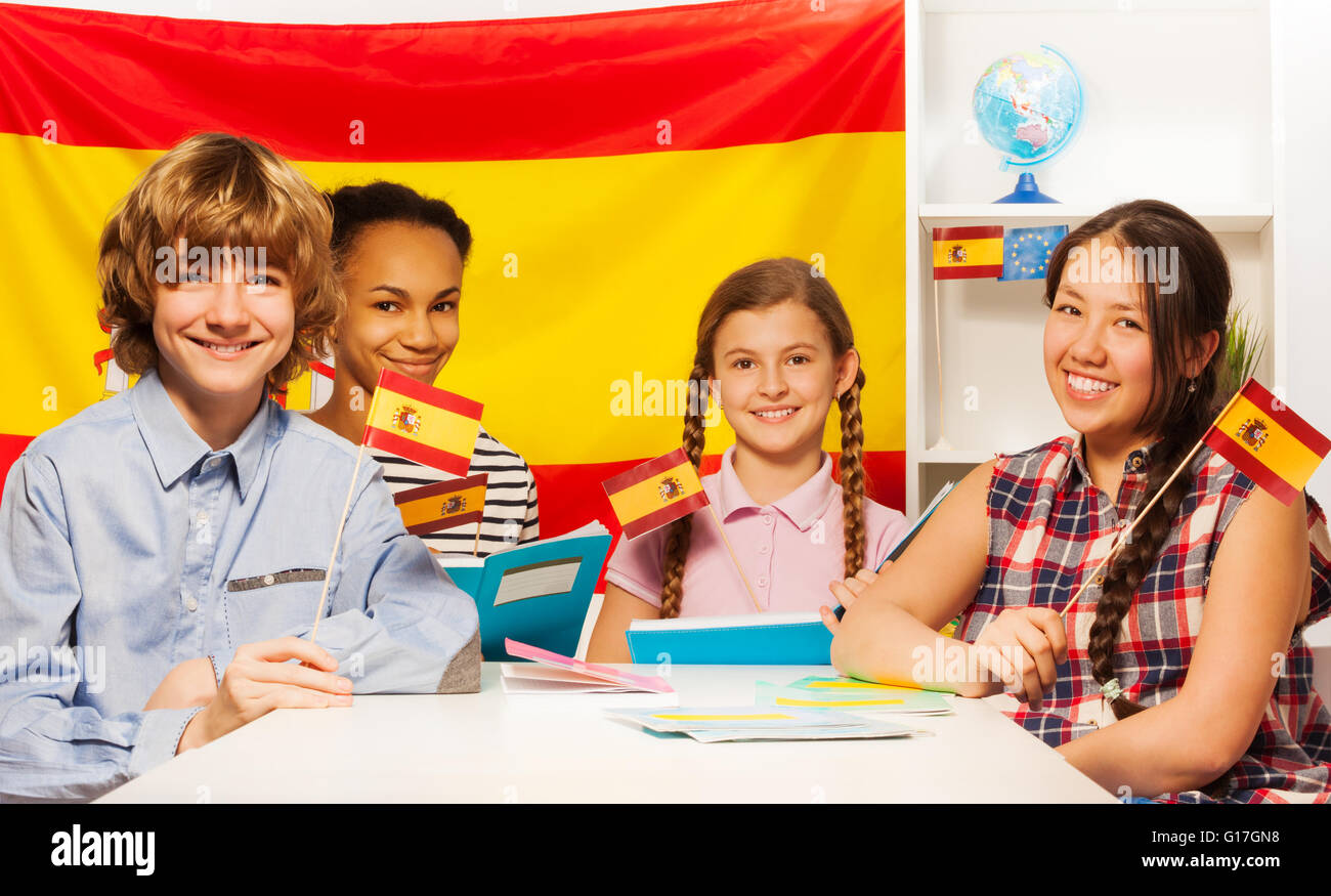Four happy multiethnic students holding flags Stock Photo - Alamy