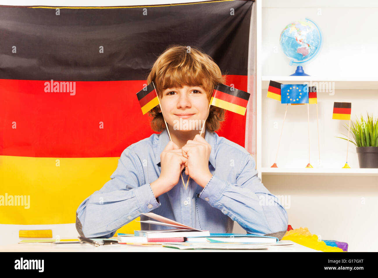 Student with two flags of Germany sitting at class Stock Photo - Alamy
