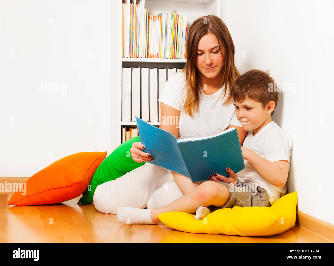 Mother reading a story to her kid son Stock Photo - Alamy